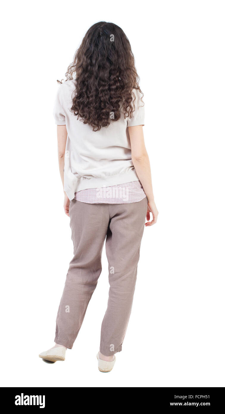 back view of standing young beautiful woman. girl watching. Rear view ...