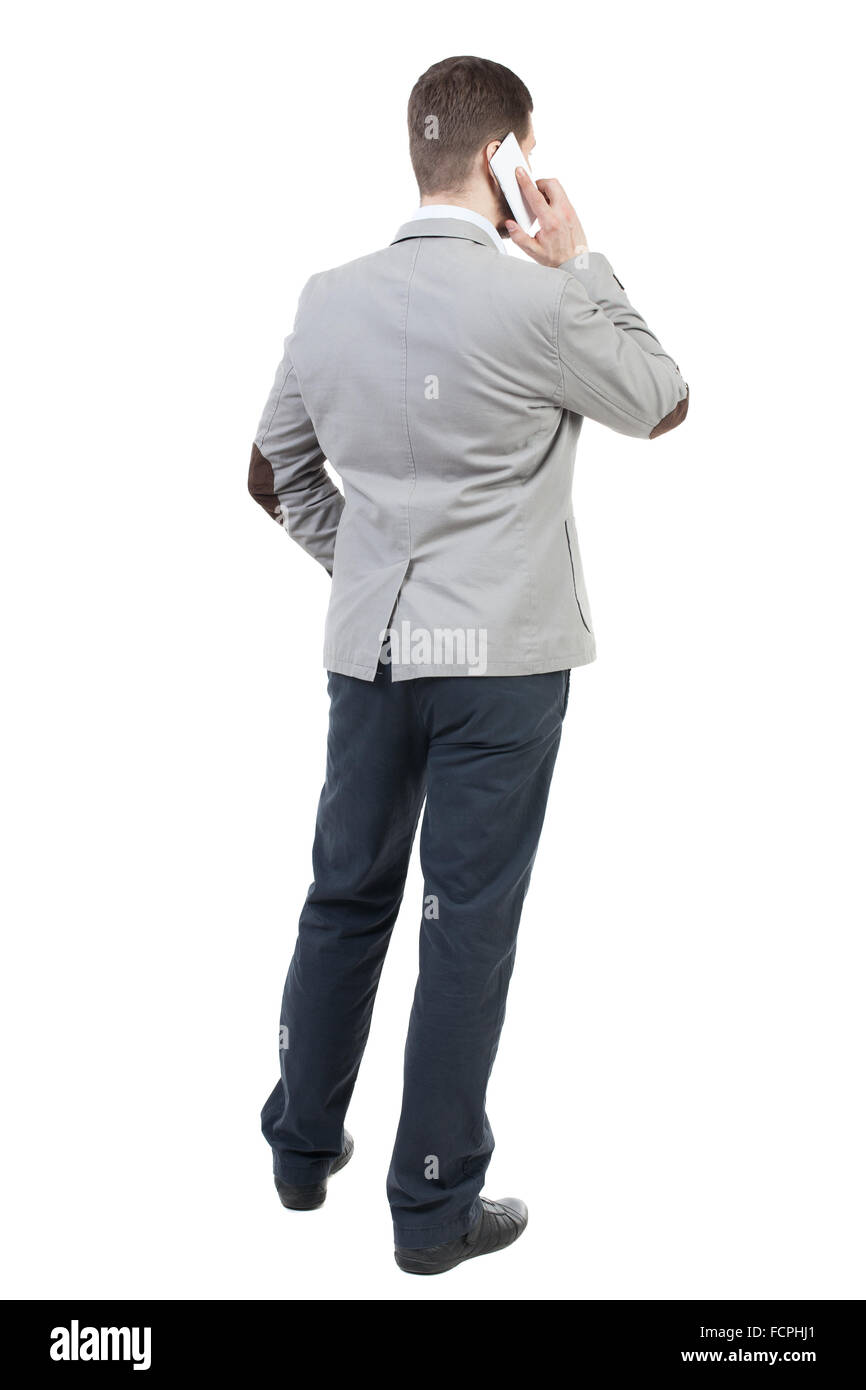 back view of business man in suit talking on mobile phone. rear view ...