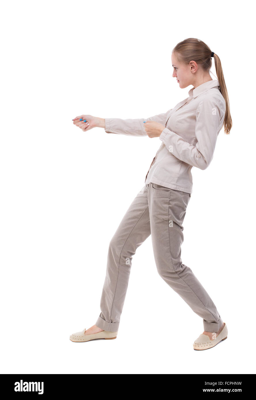 back view of standing girl pulling a rope from the top or cling to ...