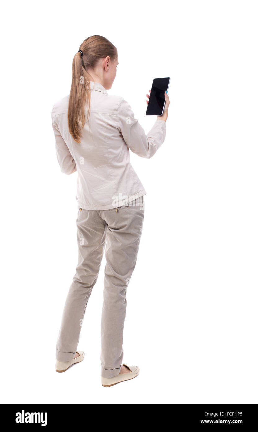 back view of standing young beautiful girl with tablet computer in the ...