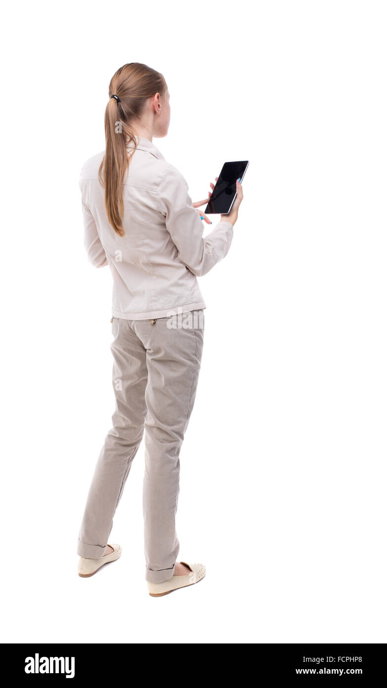 back view of standing young beautiful girl with tablet computer in the ...
