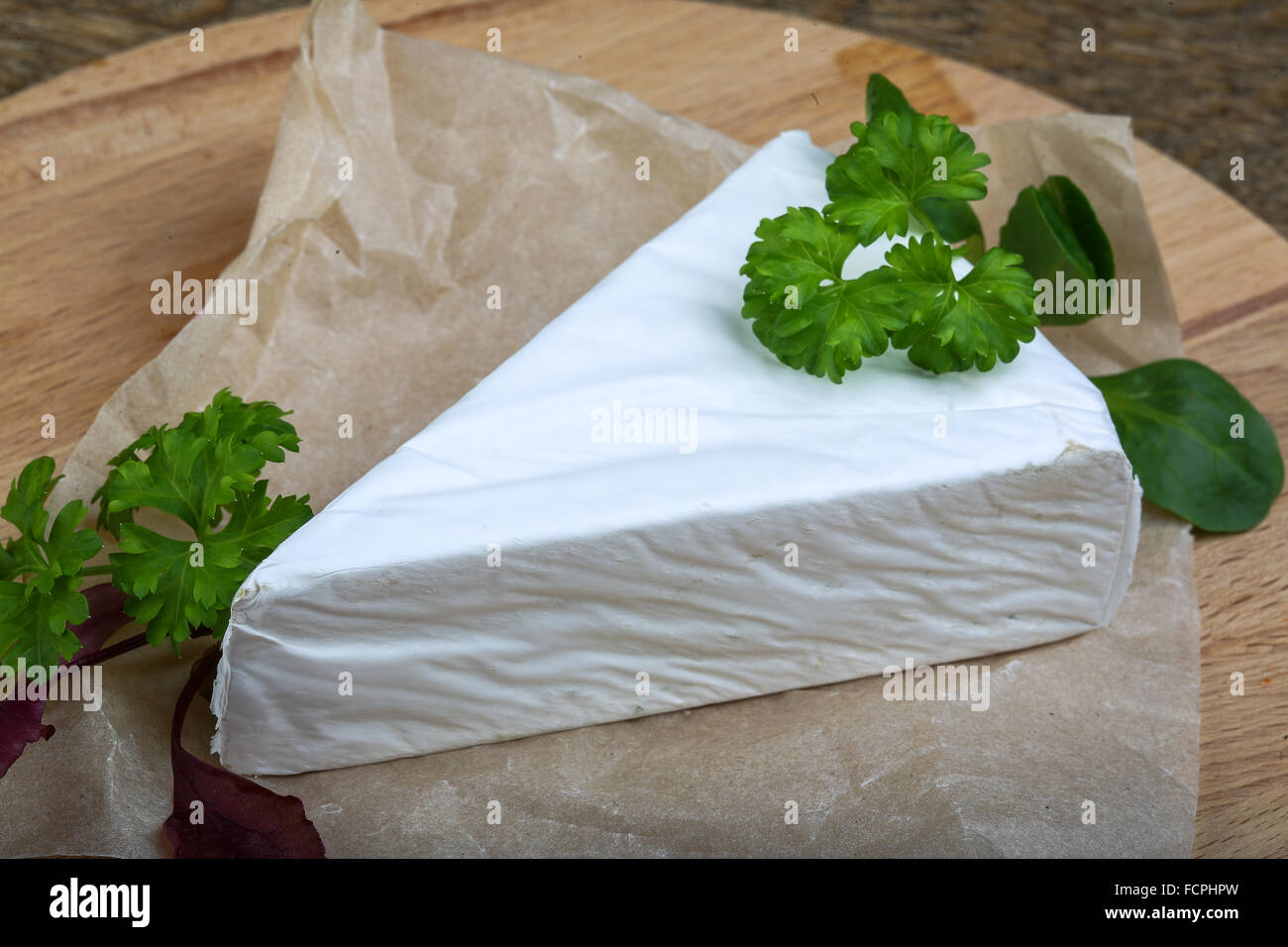 Soft brie cheese served parsley leaves on wooden background Stock Photo ...