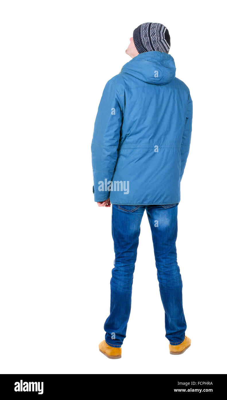 Back view of handsome man in winter jacket looking up. Standing young ...