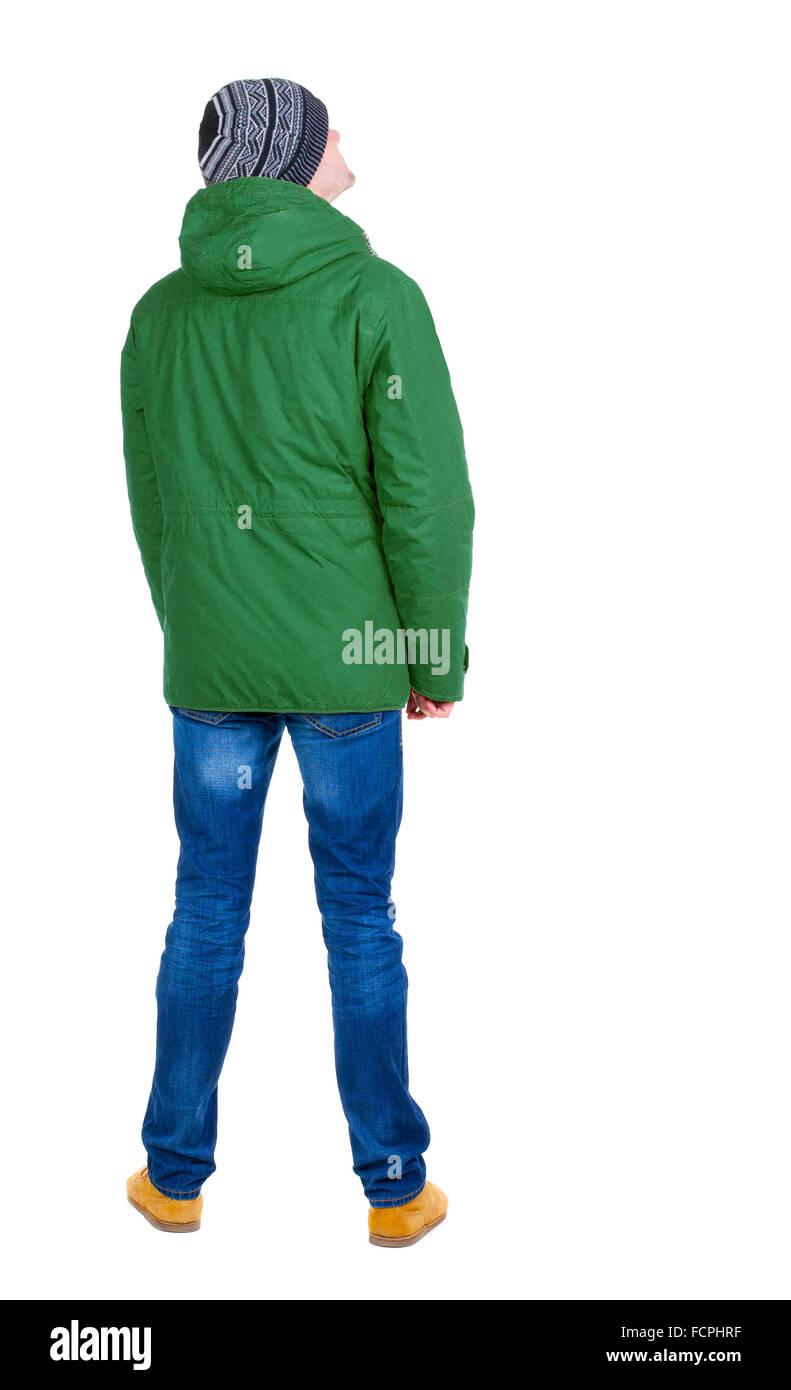 Back view of handsome man in winter jacket looking up. Standing young ...