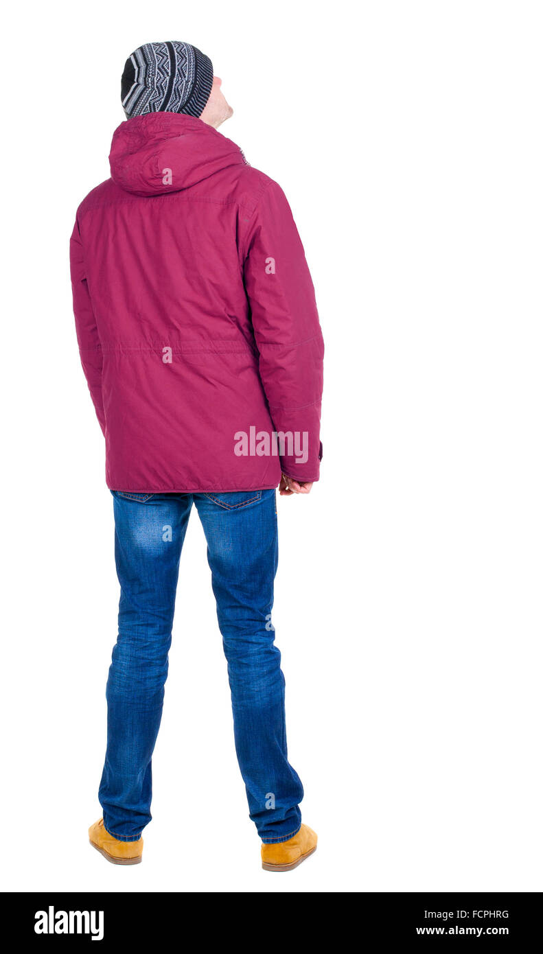 Back view of handsome man in winter jacket looking up. Standing young ...