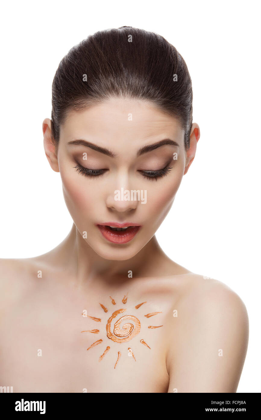 Girl with cream sun shape drawing on chest Stock Photo - Alamy