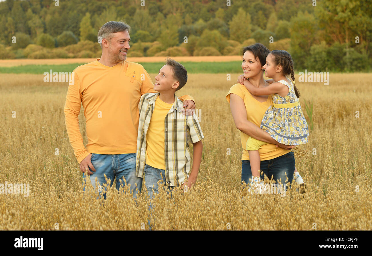 Happy family in wheat field Stock Photo - Alamy