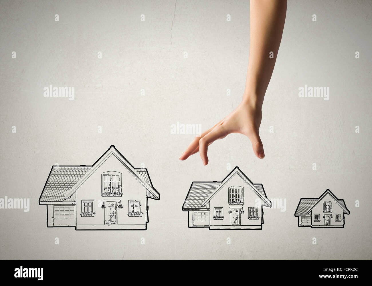 Human hand grabs drawn on paper house Stock Photo - Alamy