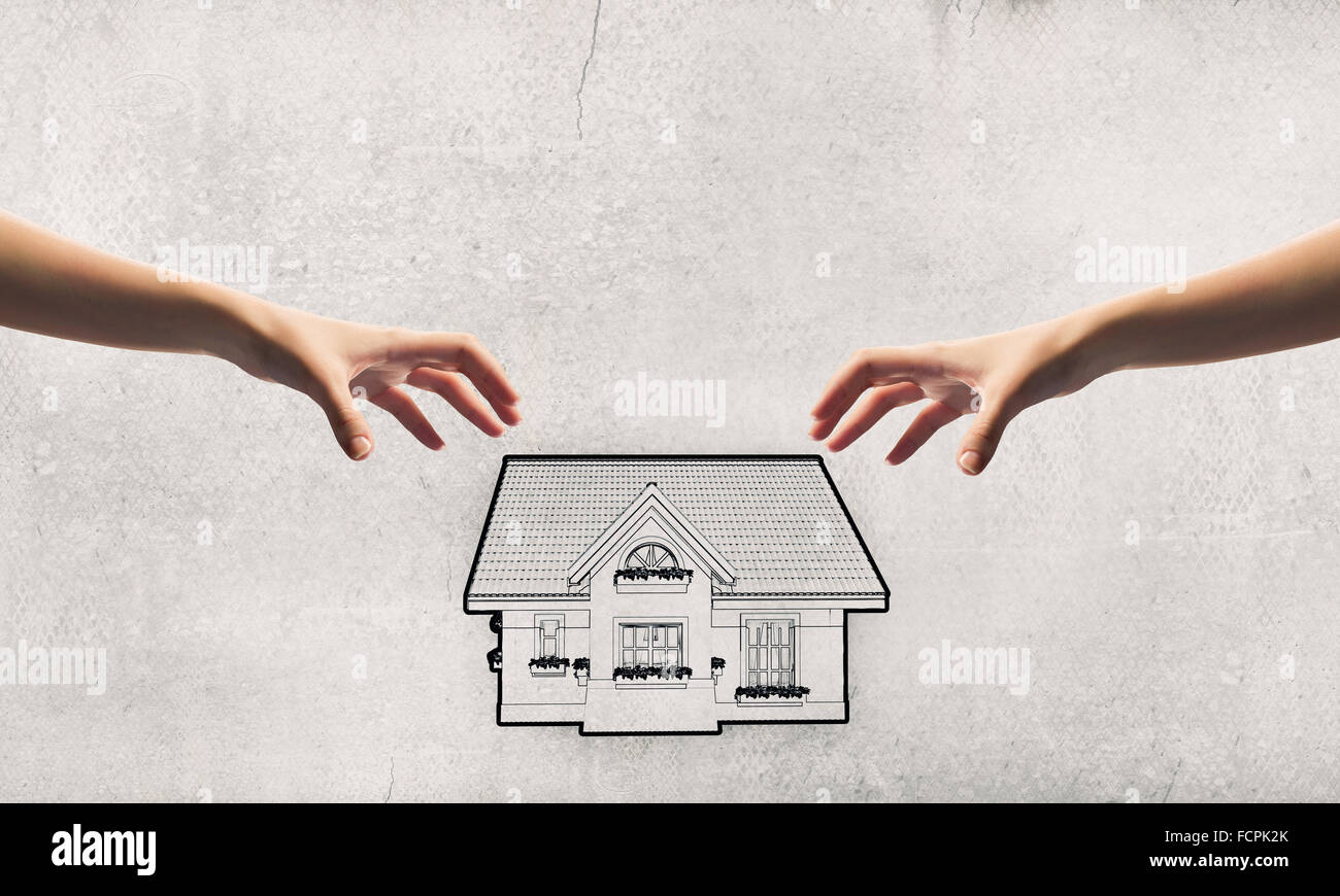 Human hand grabs drawn on paper house Stock Photo - Alamy