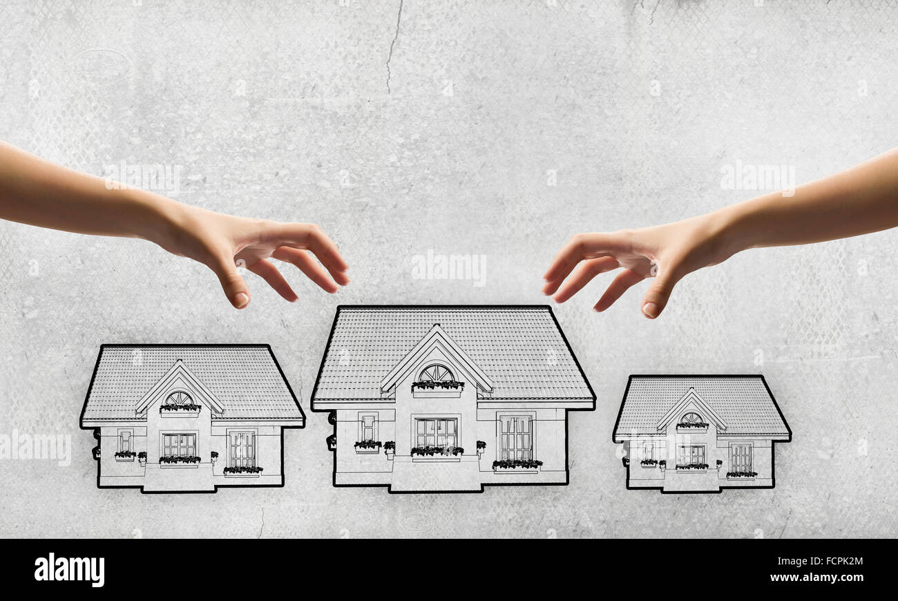 Human hand grabs drawn on paper house Stock Photo - Alamy