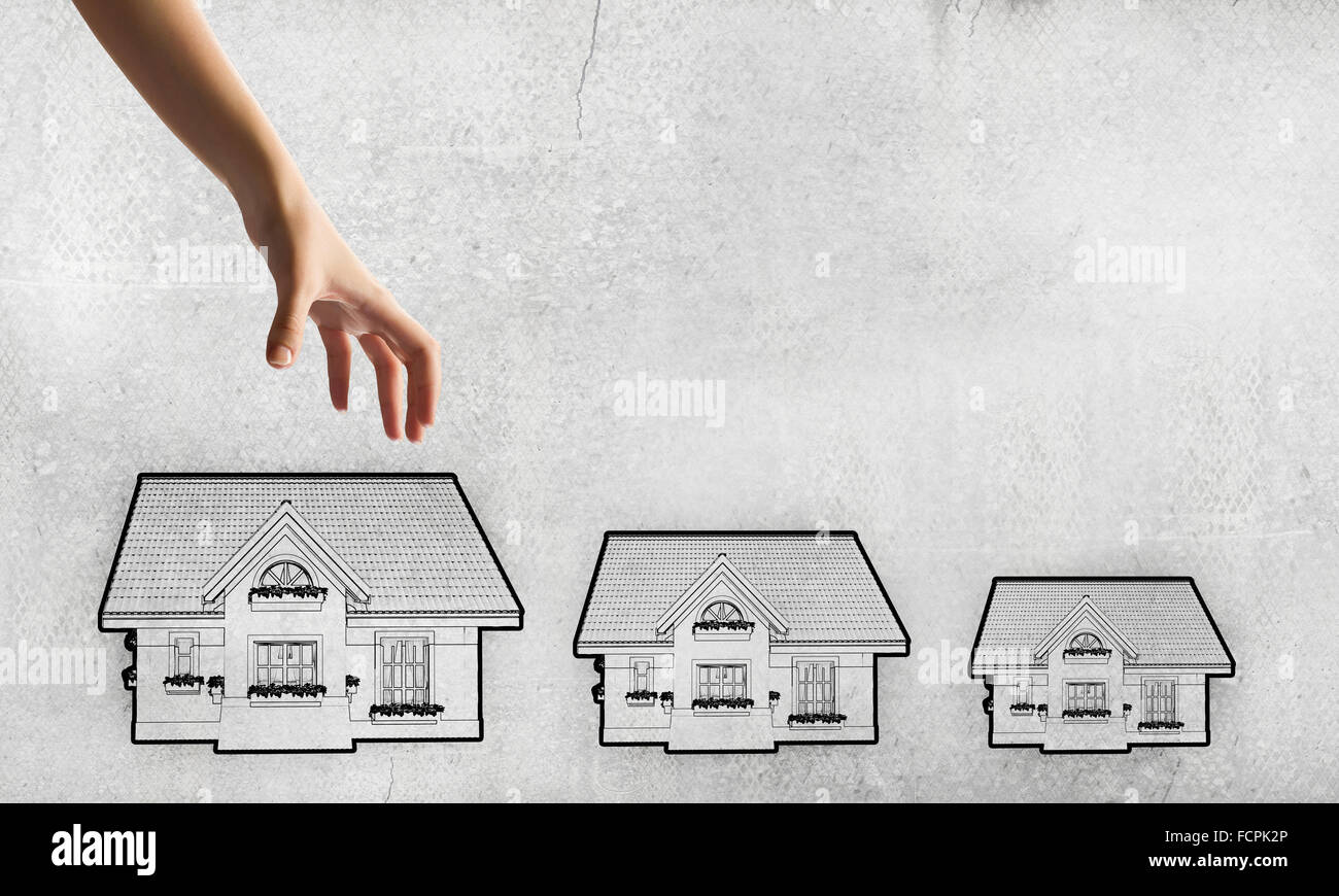Human hand grabs drawn on paper house Stock Photo - Alamy