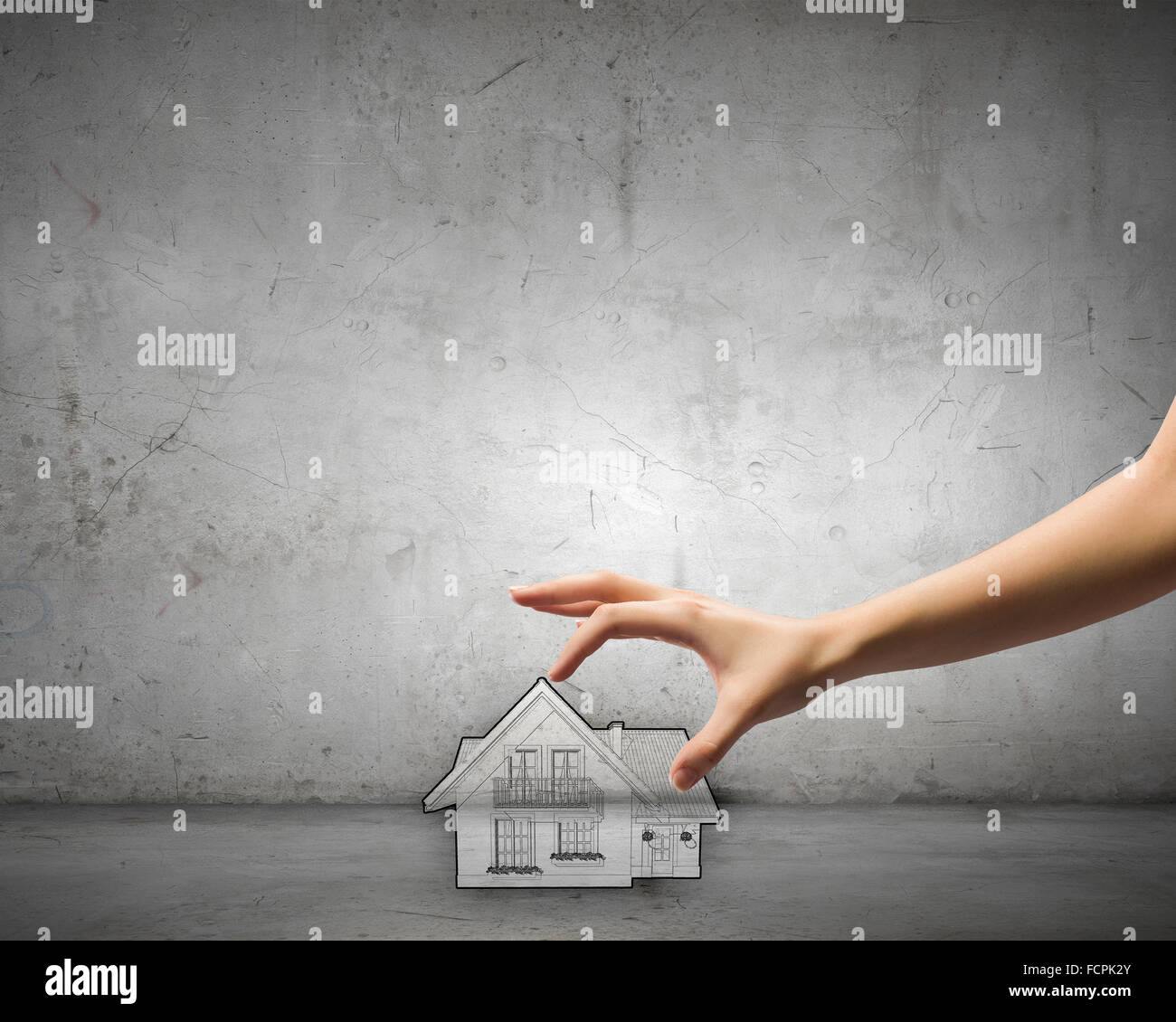 Human hand grabs drawn on paper house Stock Photo - Alamy