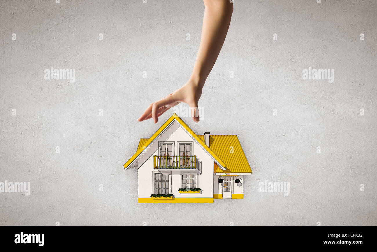 Human hand grabs drawn on paper house Stock Photo - Alamy