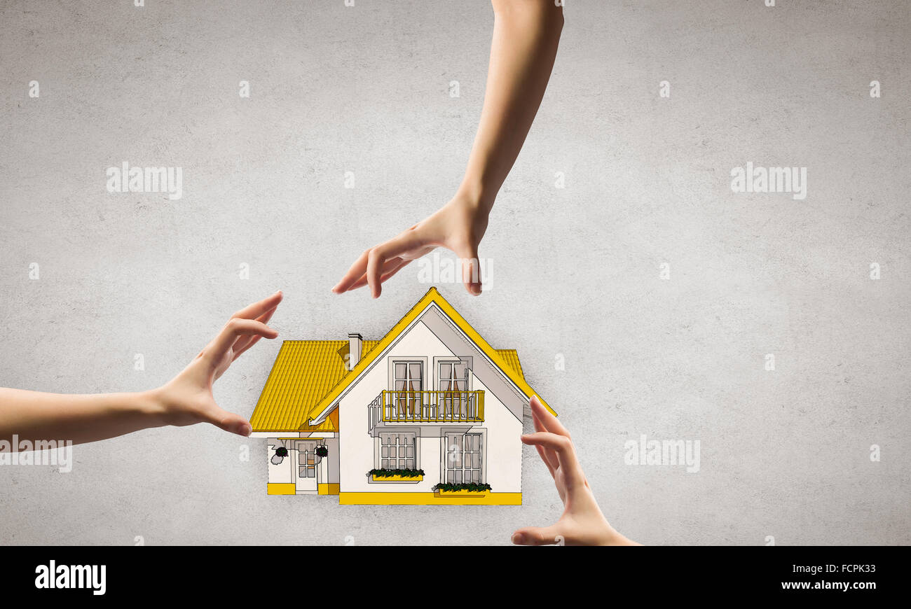 Human hand grabs drawn on paper house Stock Photo - Alamy