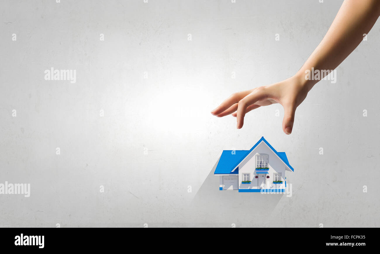 Human hand grabs drawn on paper house Stock Photo - Alamy