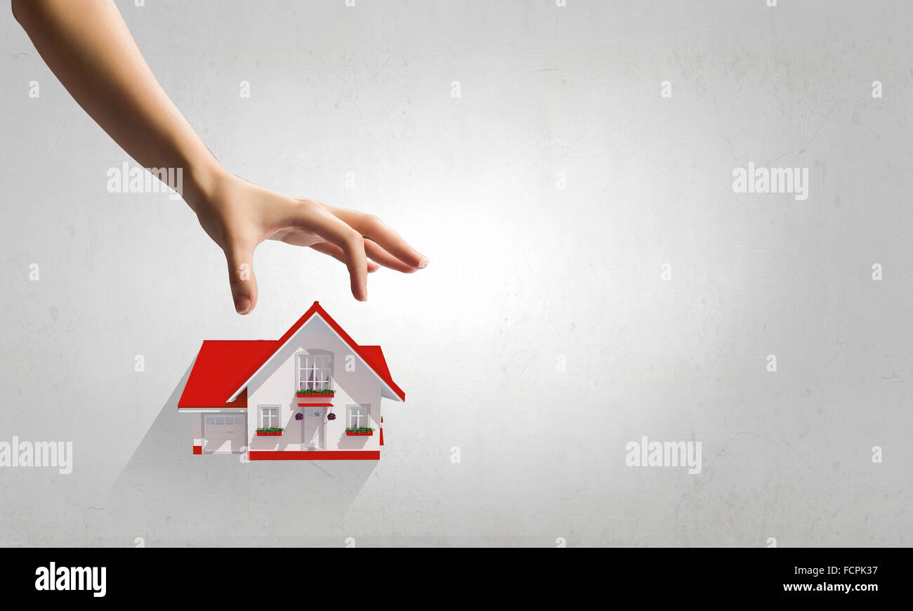 Human hand grabs drawn on paper house Stock Photo - Alamy