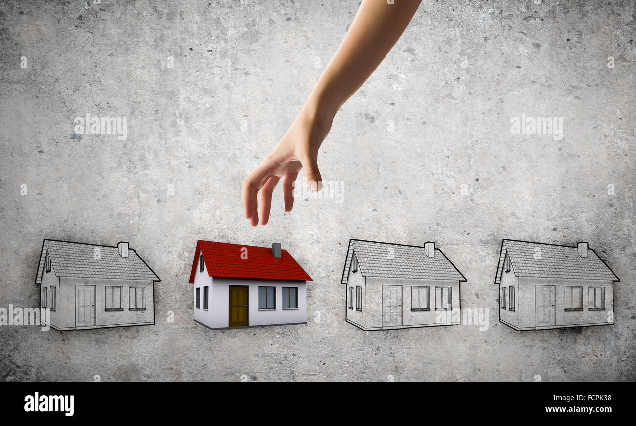 Human hand grabs drawn on paper house Stock Photo - Alamy