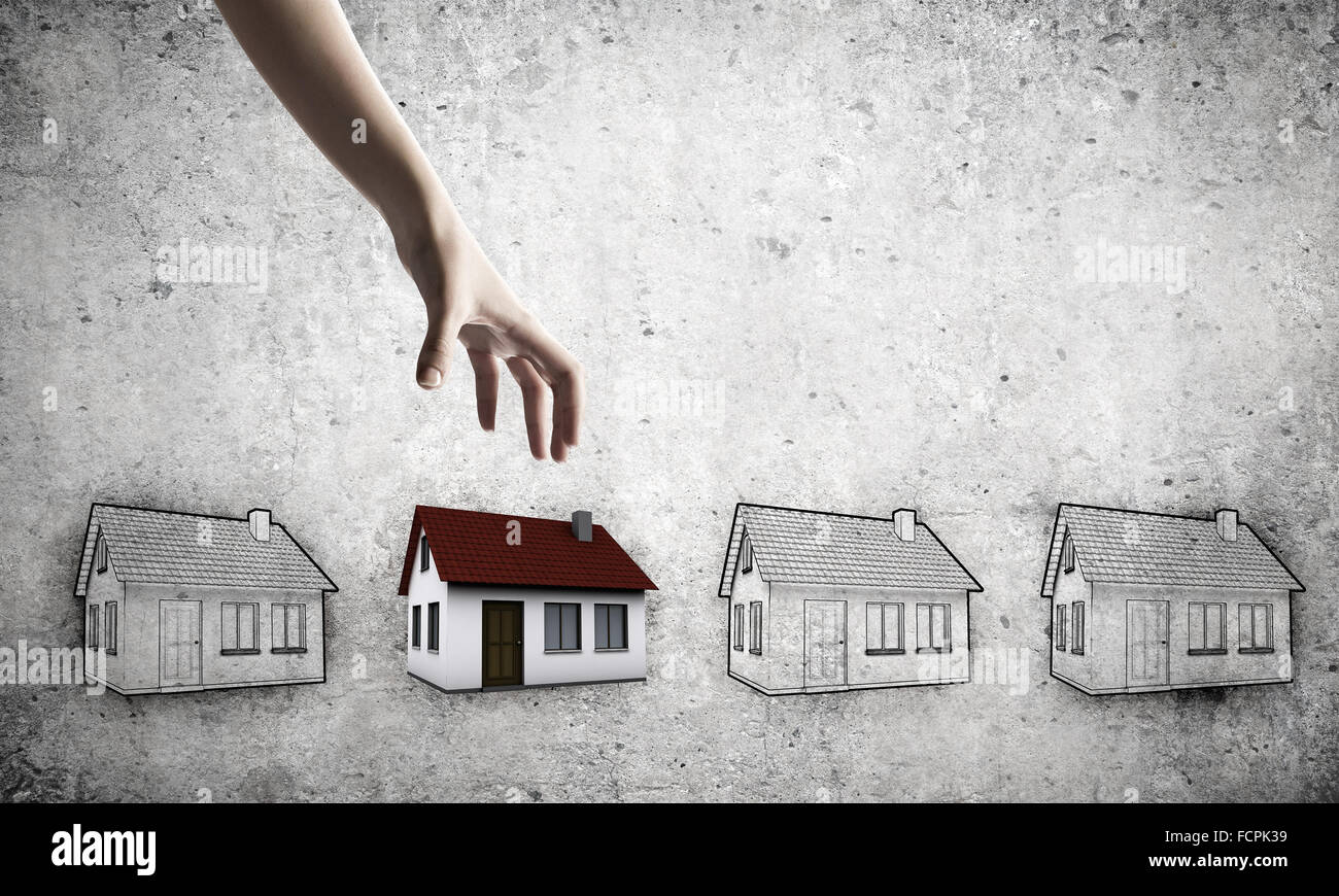 Human hand grabs drawn on paper house Stock Photo - Alamy