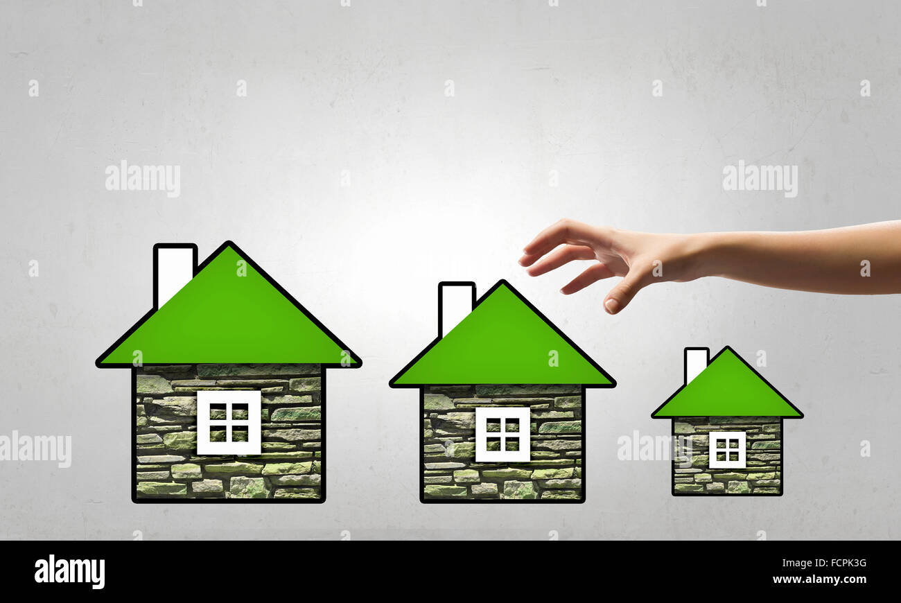 Human hand grabs drawn on paper house Stock Photo - Alamy