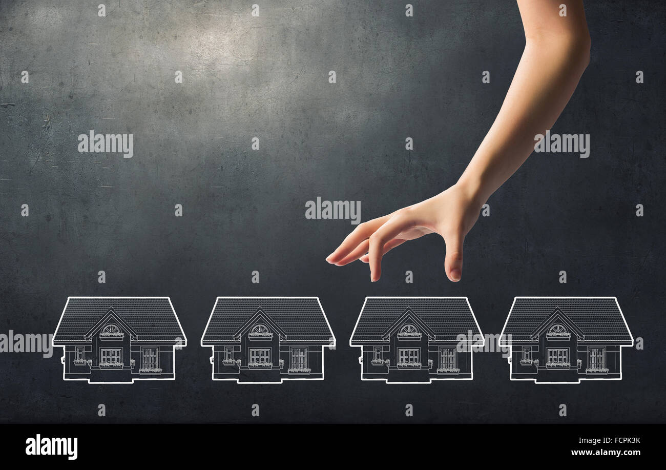 Human hand grabs drawn on paper house Stock Photo - Alamy