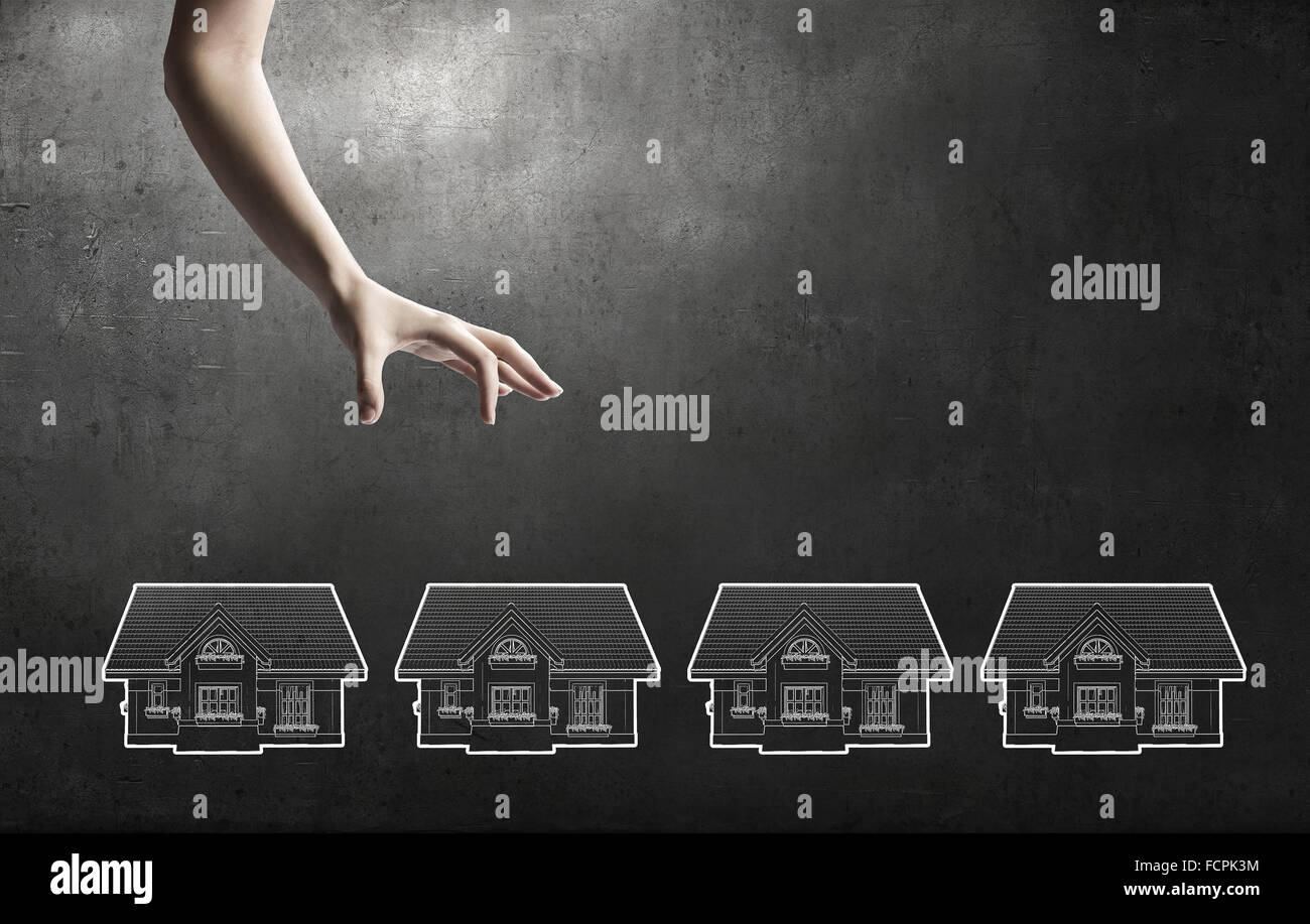 Human hand grabs drawn on paper house Stock Photo - Alamy