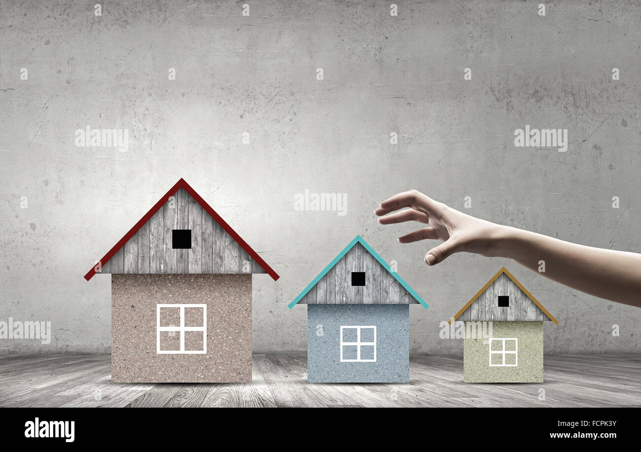 Human hand grabs drawn on paper house Stock Photo - Alamy