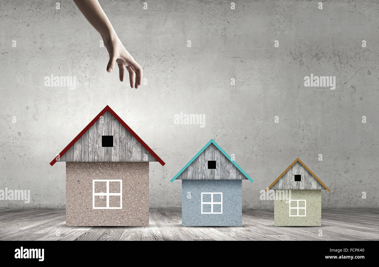 Human hand grabs drawn on paper house Stock Photo - Alamy