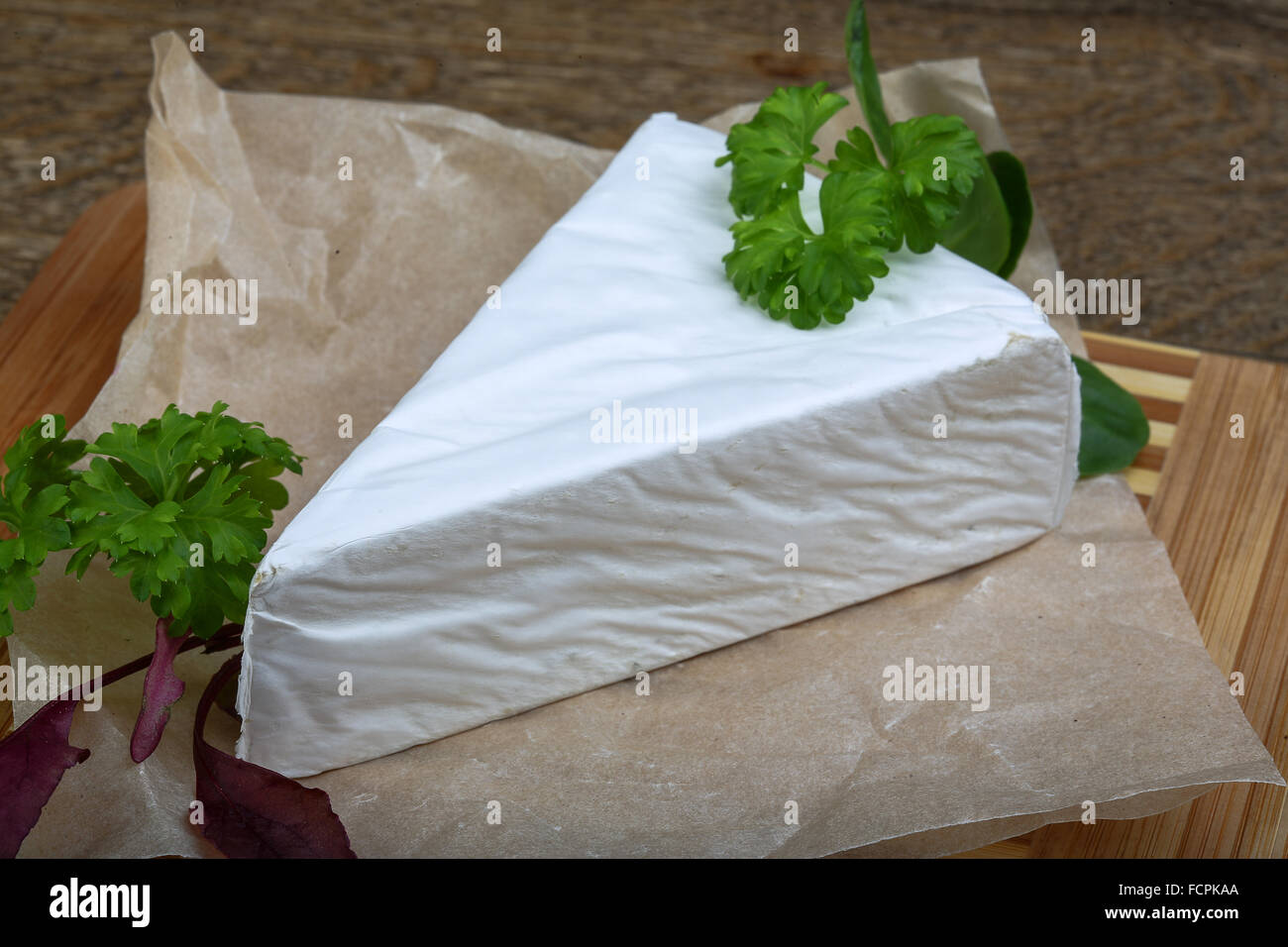 Soft brie cheese served parsley leaves on wooden background Stock Photo ...