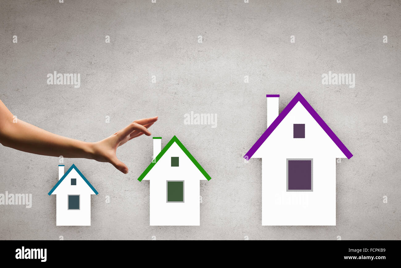 Human hand grabs drawn on paper house Stock Photo - Alamy