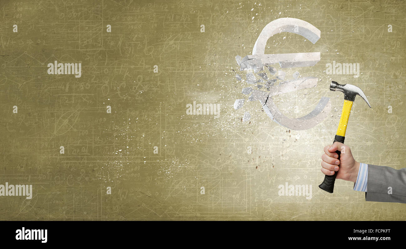 Close up of hammer in human hand breaking stone euro symbol Stock Photo ...