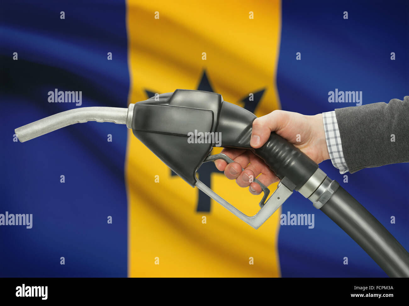 Fuel pump nozzle in hand with flag on background - Barbados Stock Photo ...