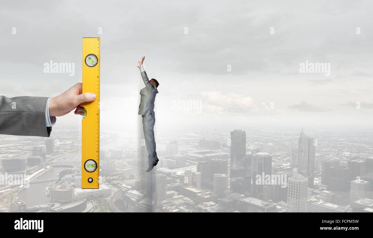 Hand measuring businessman success with wooden ruler Stock Photo - Alamy