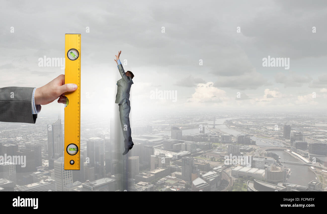 Hand measuring businessman success with wooden ruler Stock Photo - Alamy