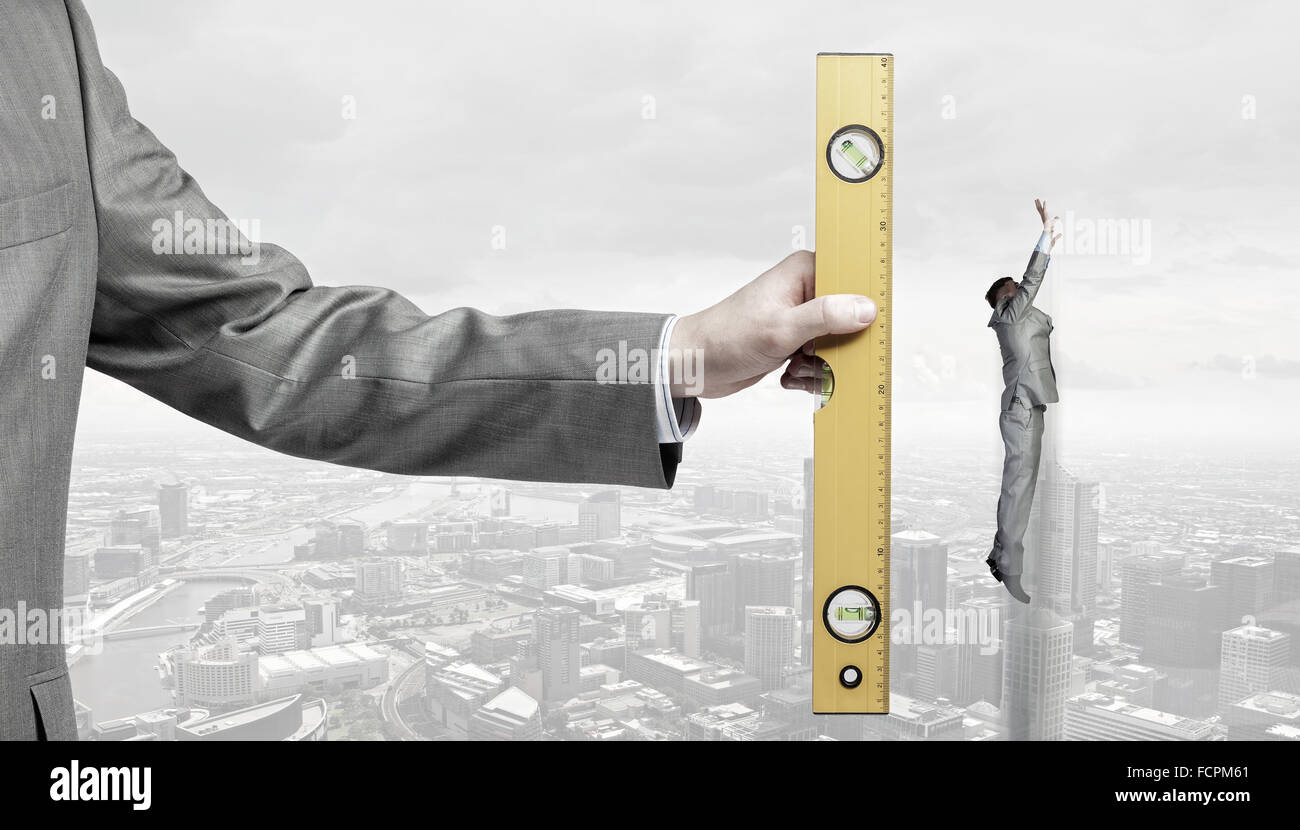 Hand measuring businessman success with wooden ruler Stock Photo - Alamy