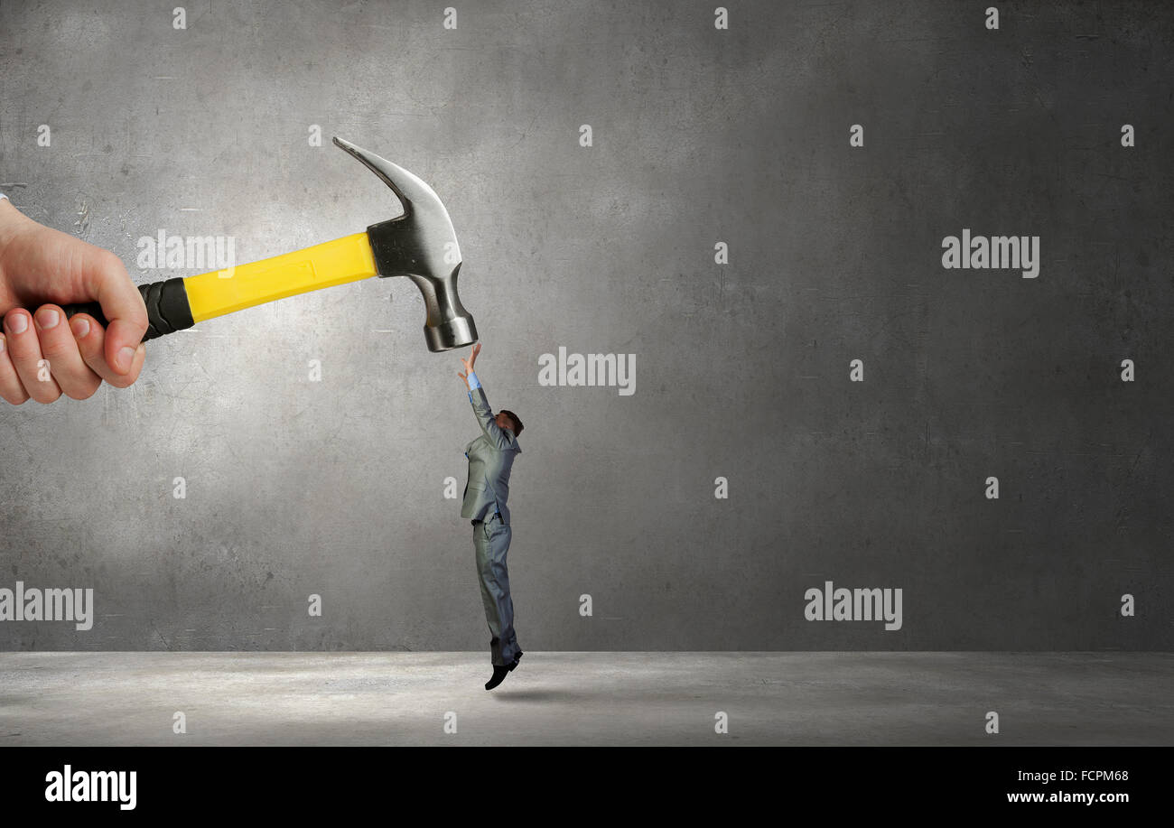 Close up of hammer in male hand attacking scared businessman Stock ...