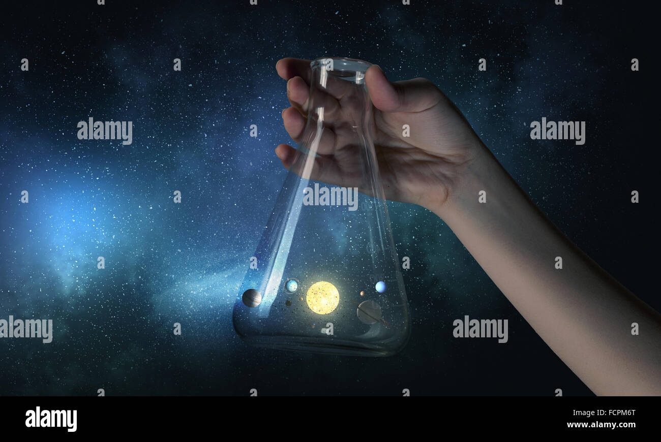 Hand holds flask with images on varied background Stock Photo - Alamy