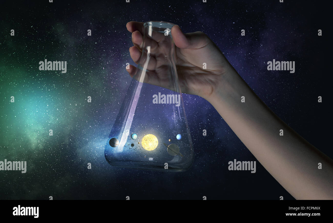 Hand holds flask with images on varied background Stock Photo - Alamy