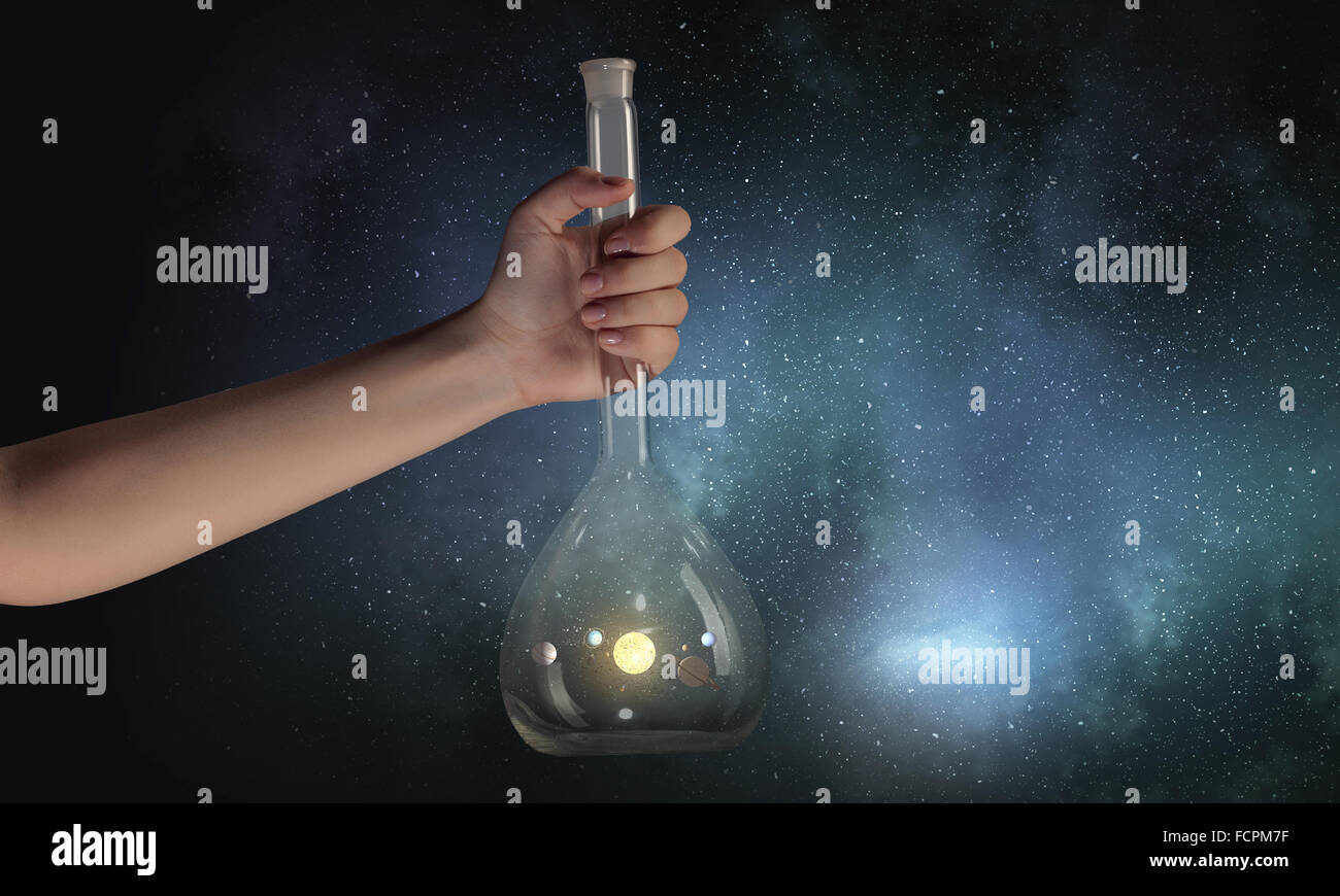 Hand holds flask with images on varied background Stock Photo - Alamy