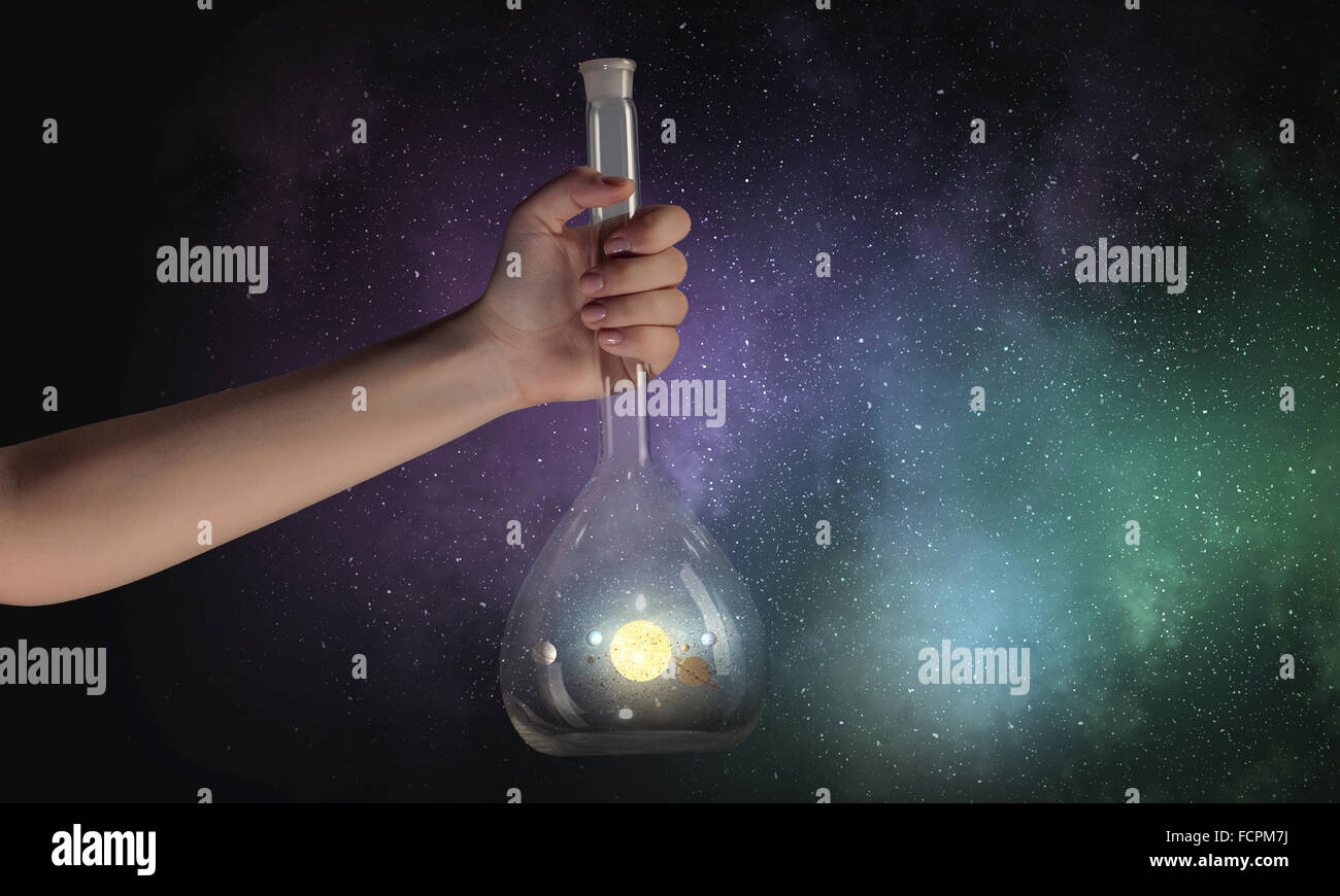 Hand holds flask with images on varied background Stock Photo - Alamy