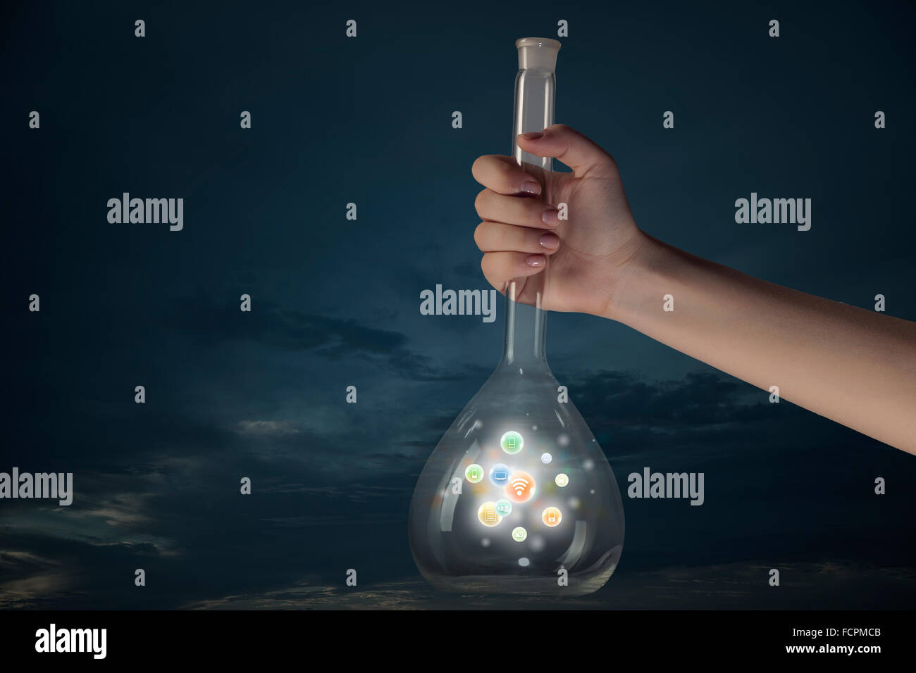 Hand holds flask with images on varied background Stock Photo - Alamy
