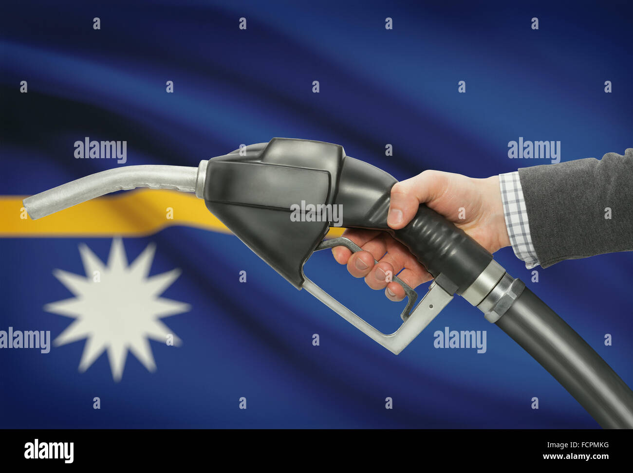 Fuel pump nozzle in hand with flag on background - Nauru Stock Photo ...