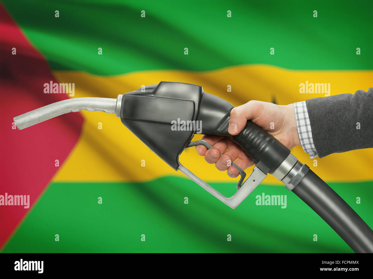 Fuel pump nozzle in hand with flag on background - Sao Tome and ...
