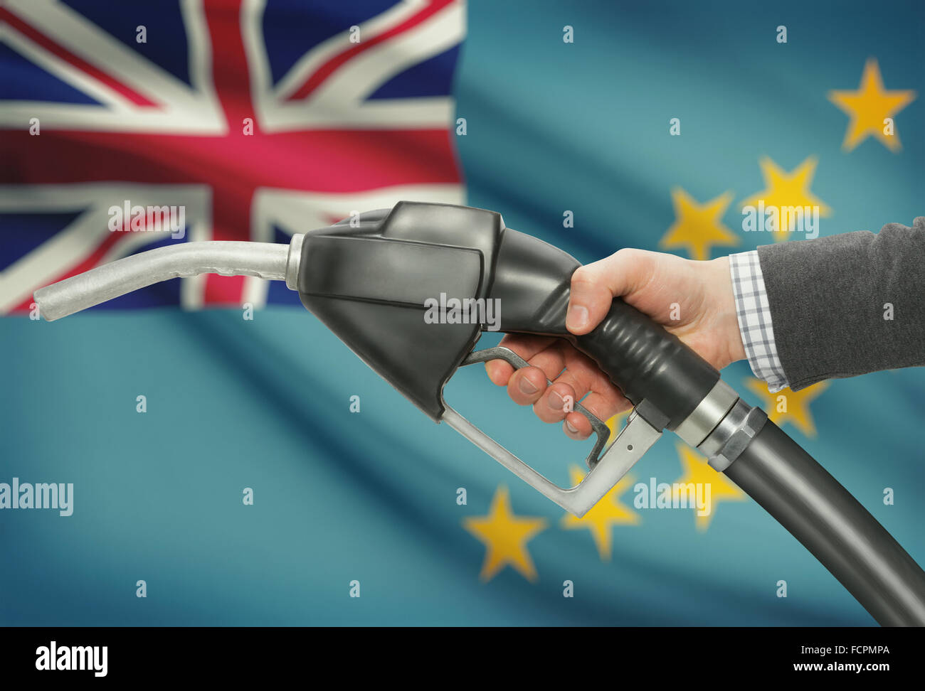Fuel pump nozzle in hand with flag on background - Tuvalu Stock Photo ...