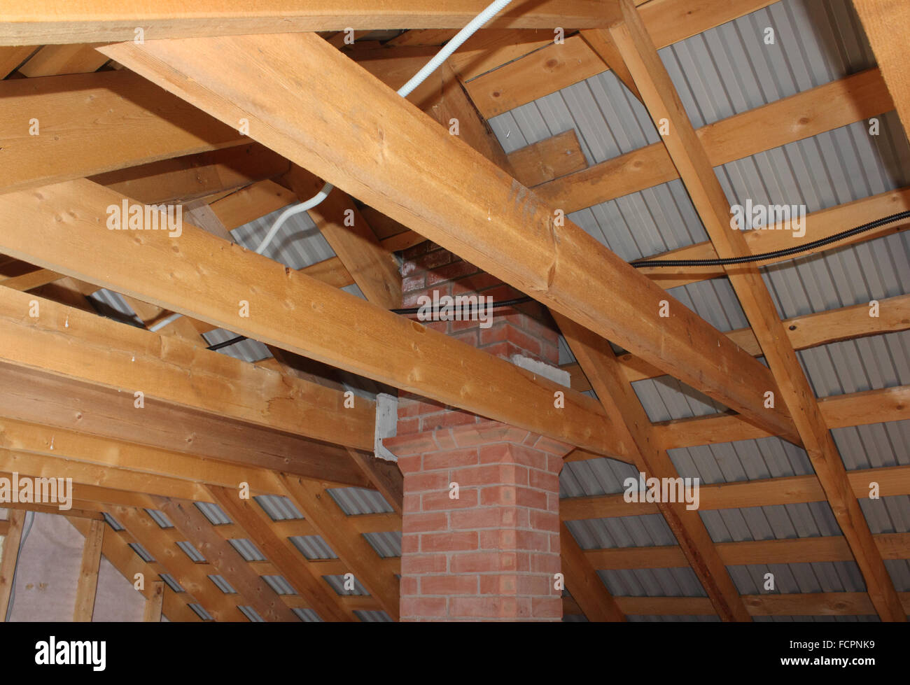 Attic with brick chimney under construction photo Stock Photo - Alamy