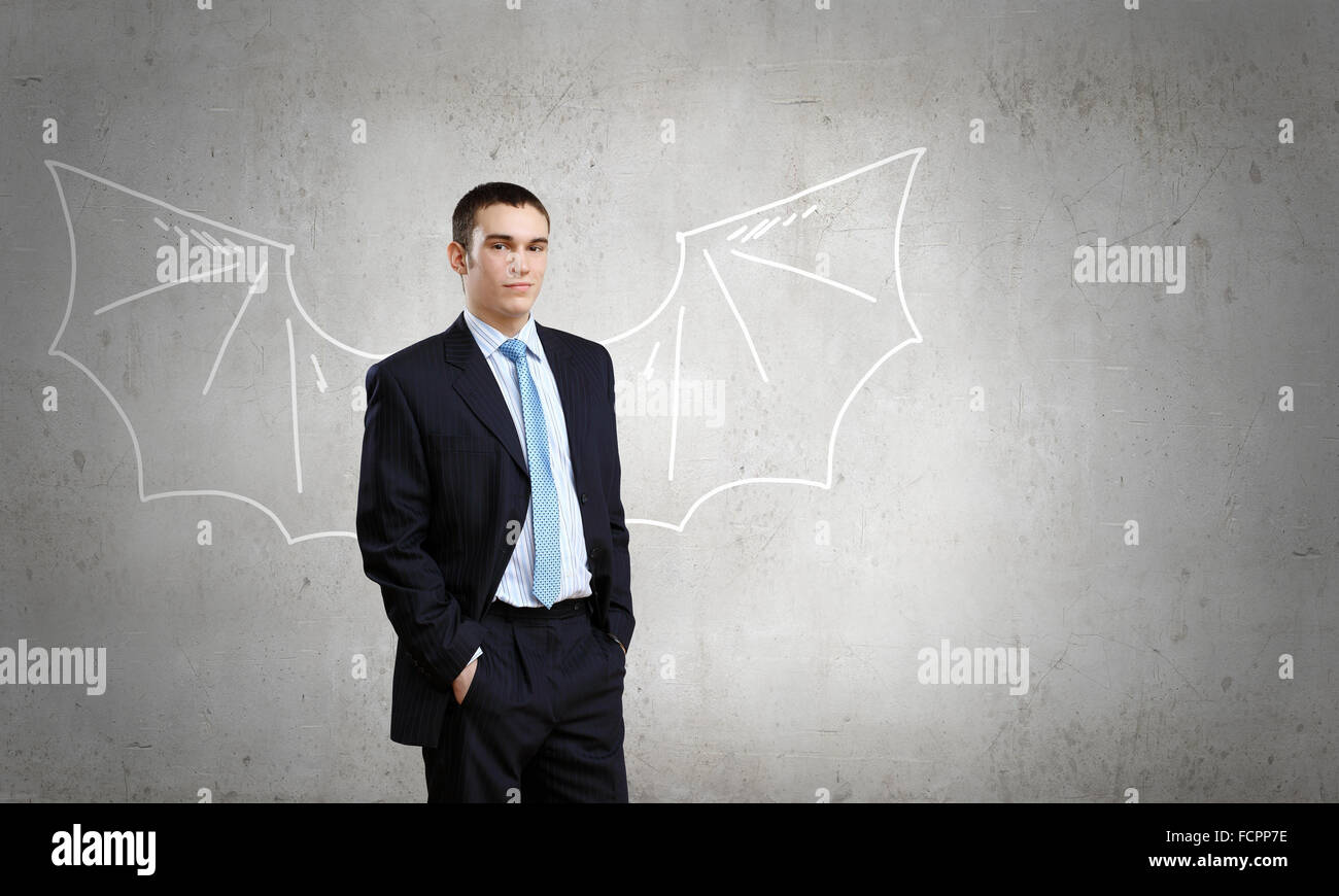 Young man with drawn wings behind back Stock Photo - Alamy