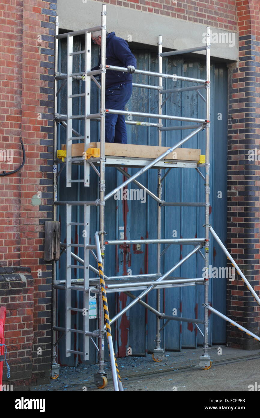 Working from a scaffold tower Stock Photo - Alamy