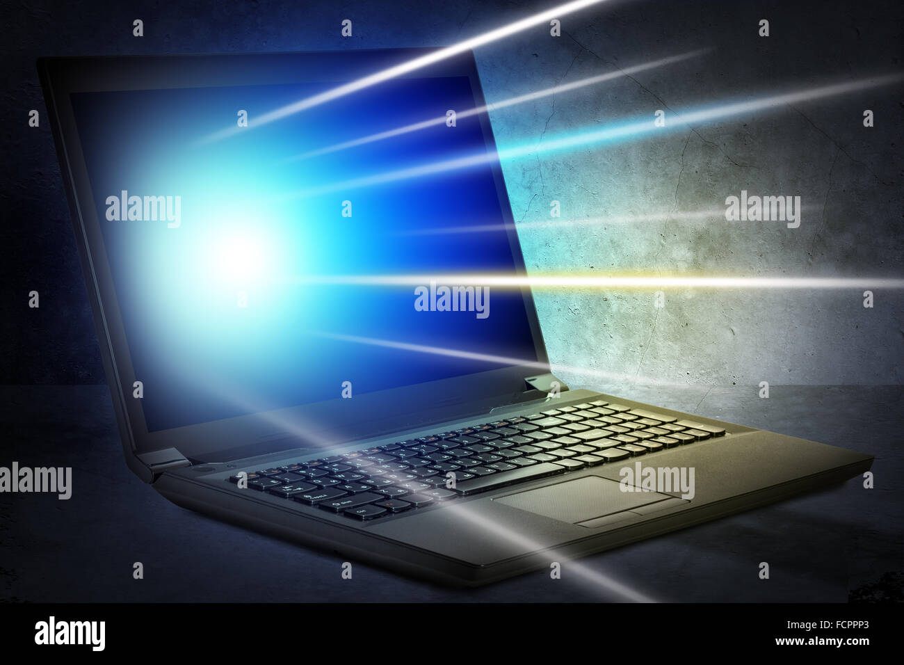 Laptop with glowing spot Stock Photo - Alamy