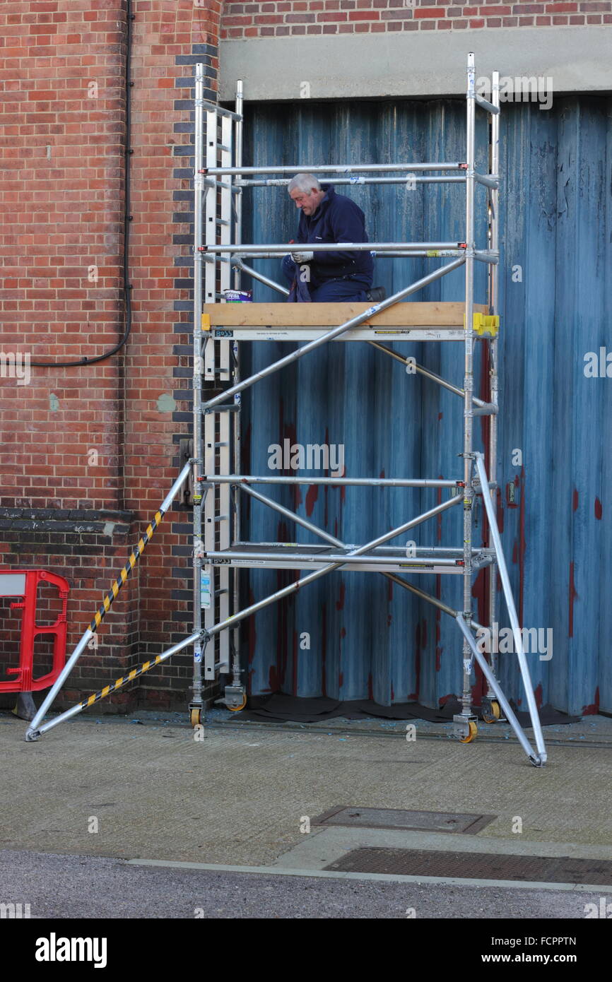 Working from a scaffold tower Stock Photo - Alamy