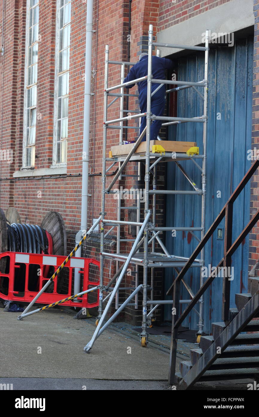 Working from a scaffold tower Stock Photo - Alamy
