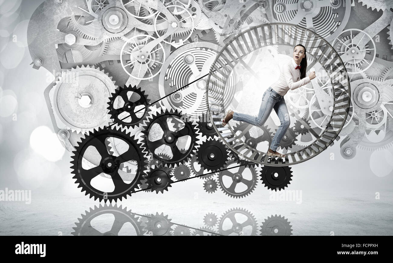 Young businesswoman running in wheel of gears mechanism Stock Photo - Alamy